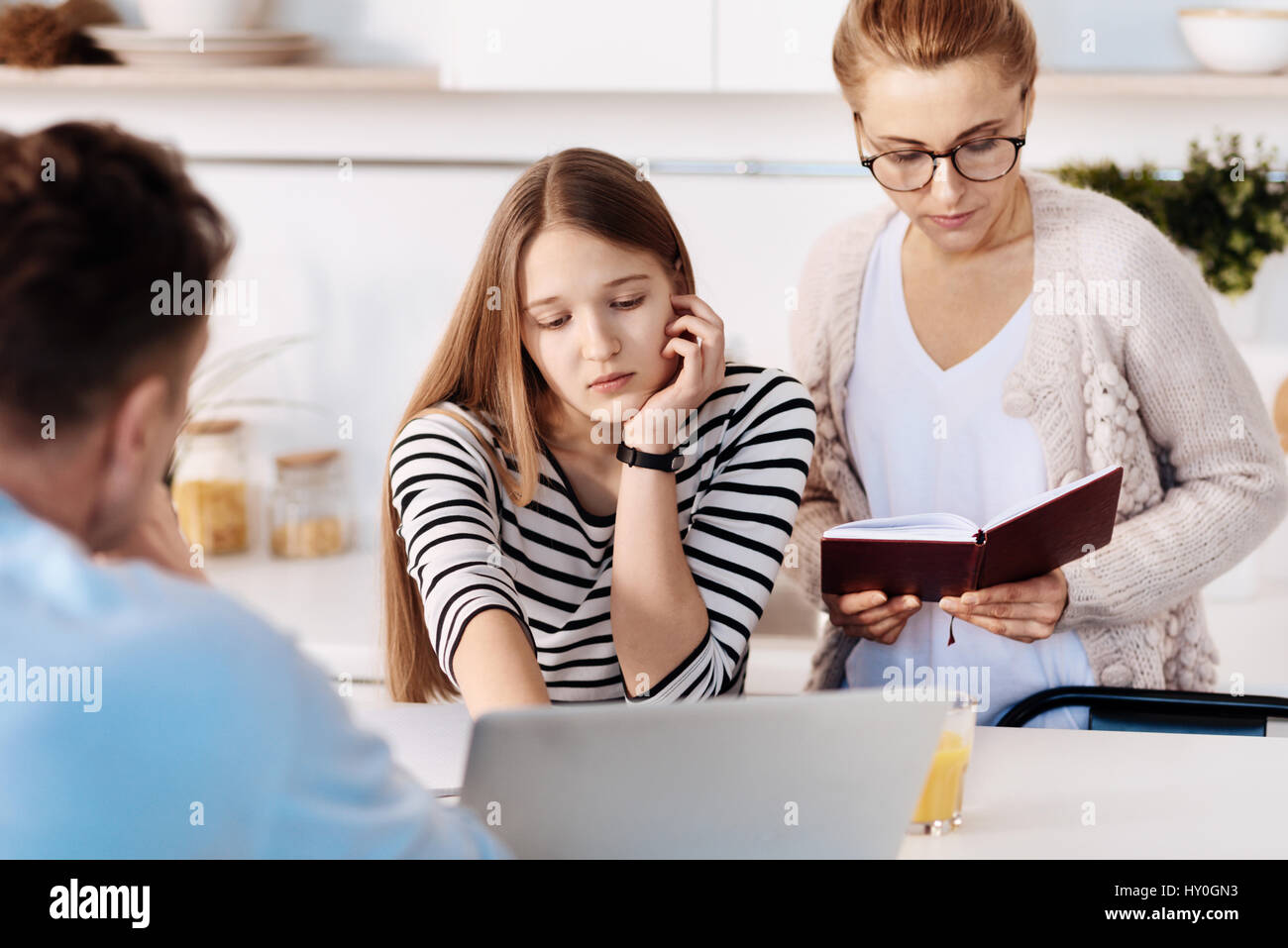Strict mother checking studying results of her daughter Stock Photo - Alamy Strict mother checking studying results of her daughter Stock Photo - Alamy
