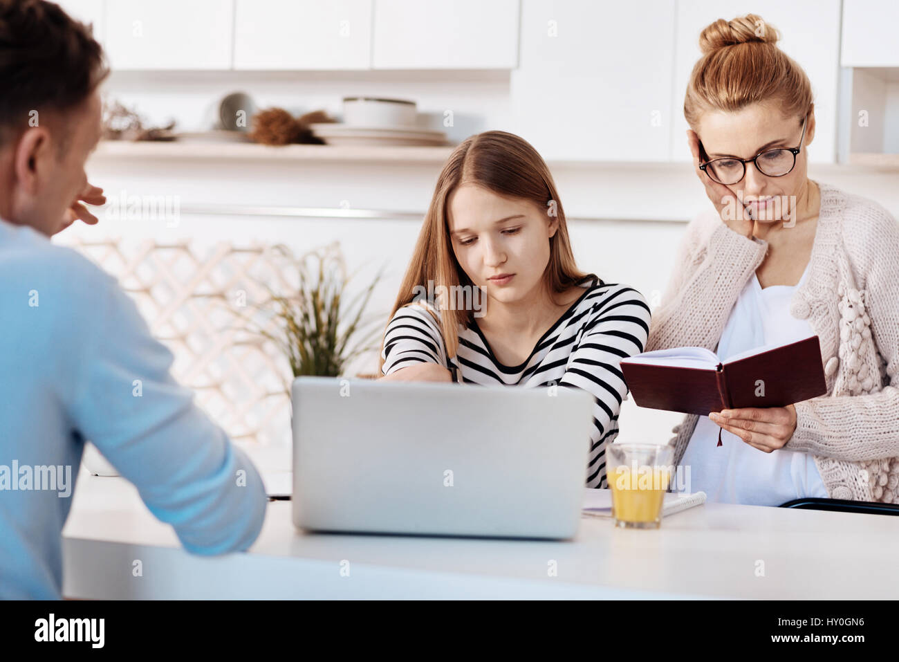 Troubled mother checking results of her daughter at school Stock Photo ...