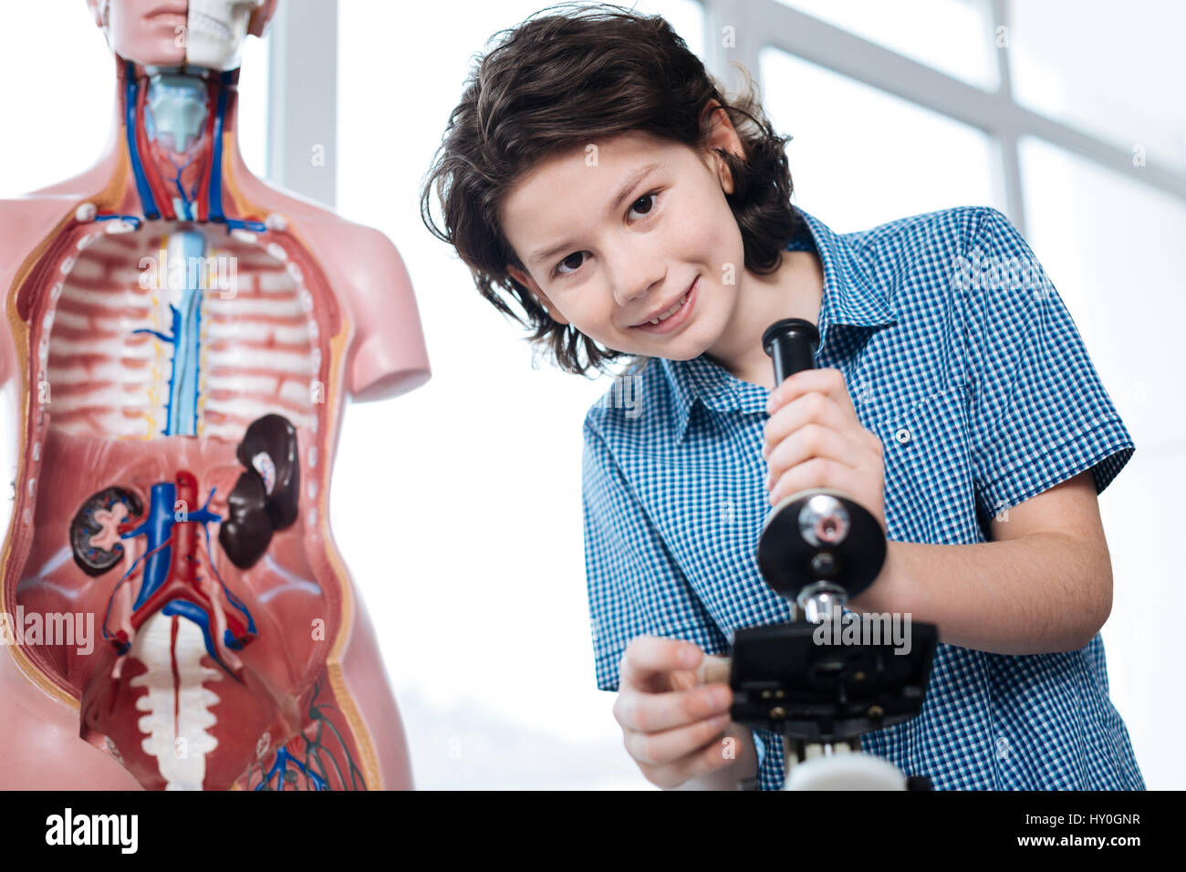 Admirable young scientist setting up a microscope Stock Photo - Alamy
