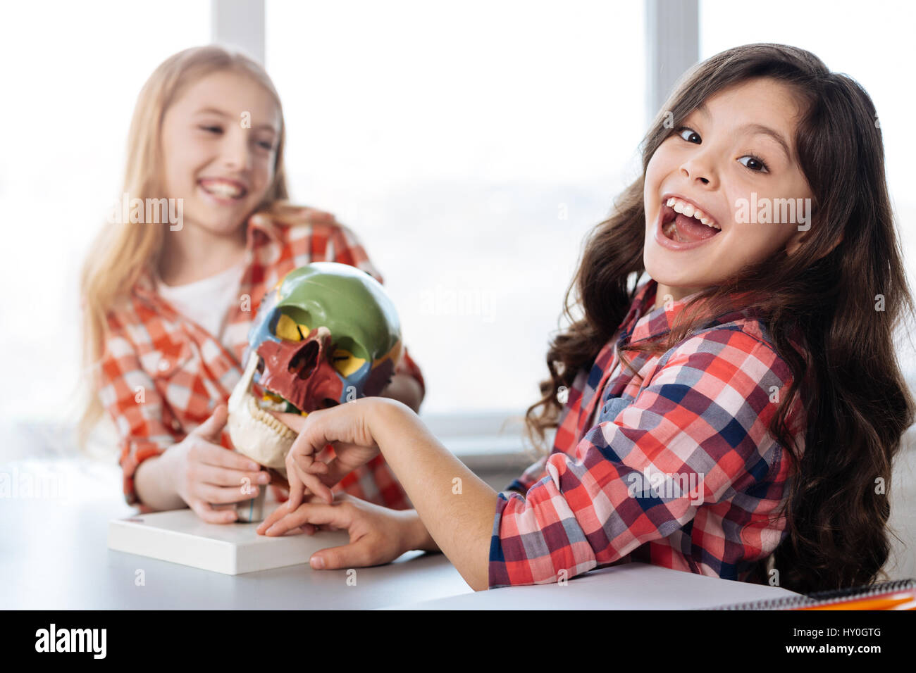 Emotional cute girl laughing at the model Stock Photo - Alamy