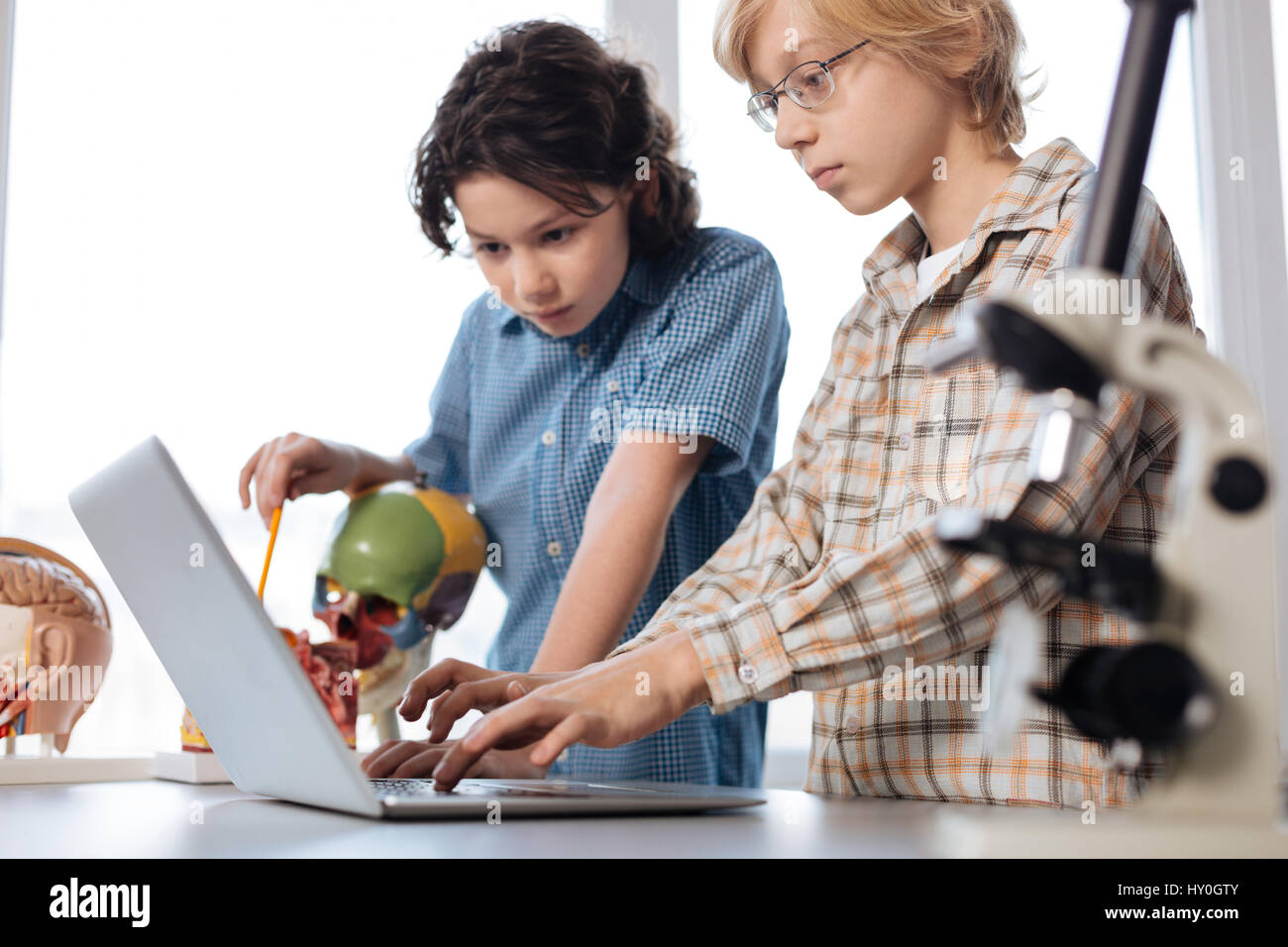 Serious young scientists concentrated on experiment Stock Photo - Alamy