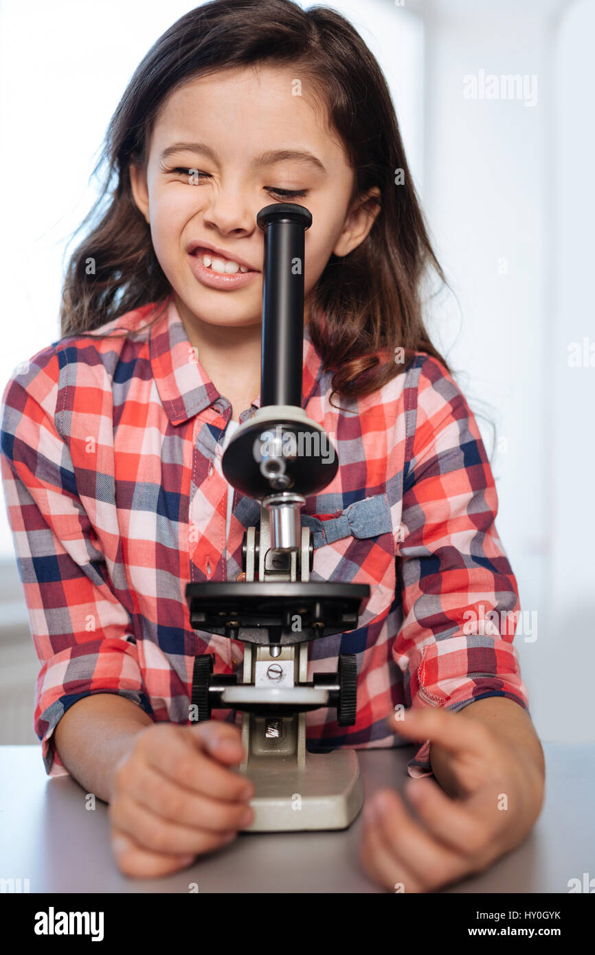 Emotional adorable child looking through a microscope Stock Photo - Alamy