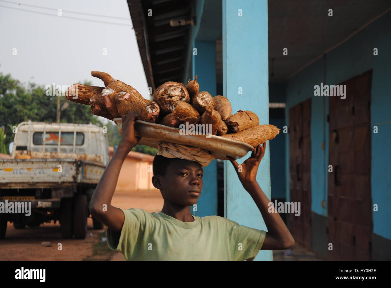 Boy carrying cassavas, Begoro, Eastern Region, Ghana, Africa Stock ...