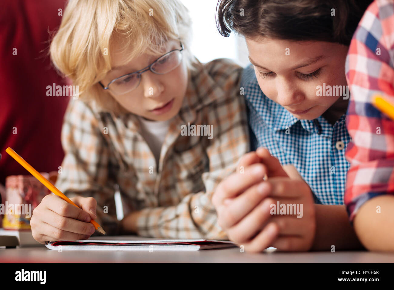 Attentive curious kids reading the assignment Stock Photo - Alamy