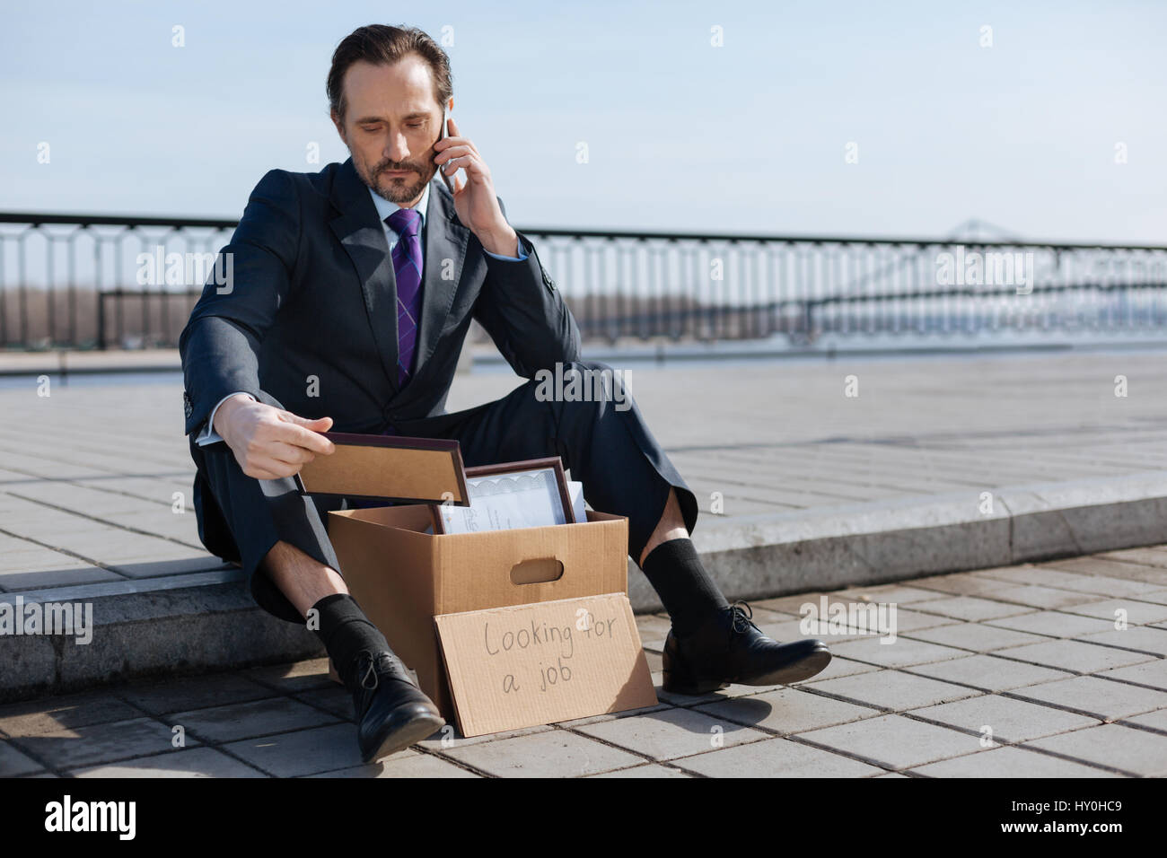 Sad man calling to his wife Stock Photo - Alamy