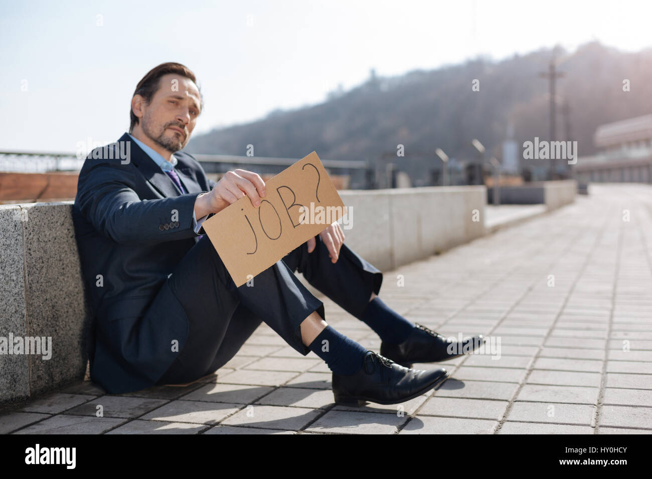 Confident man leaning on the column Stock Photo - Alamy