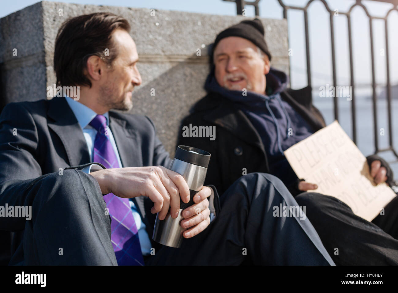 Delighted men having nice conversation Stock Photo - Alamy
