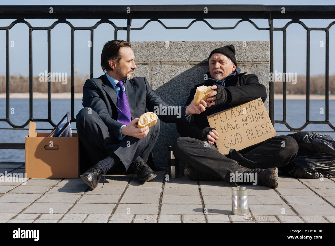 Two males going to eat some bread Stock Photo - Alamy