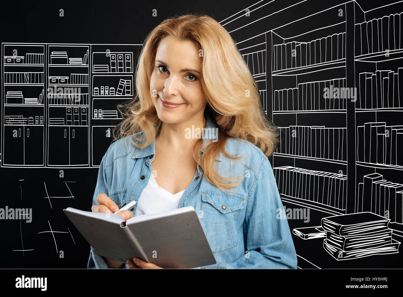 Nice good looking woman taking notes Stock Photo - Alamy
