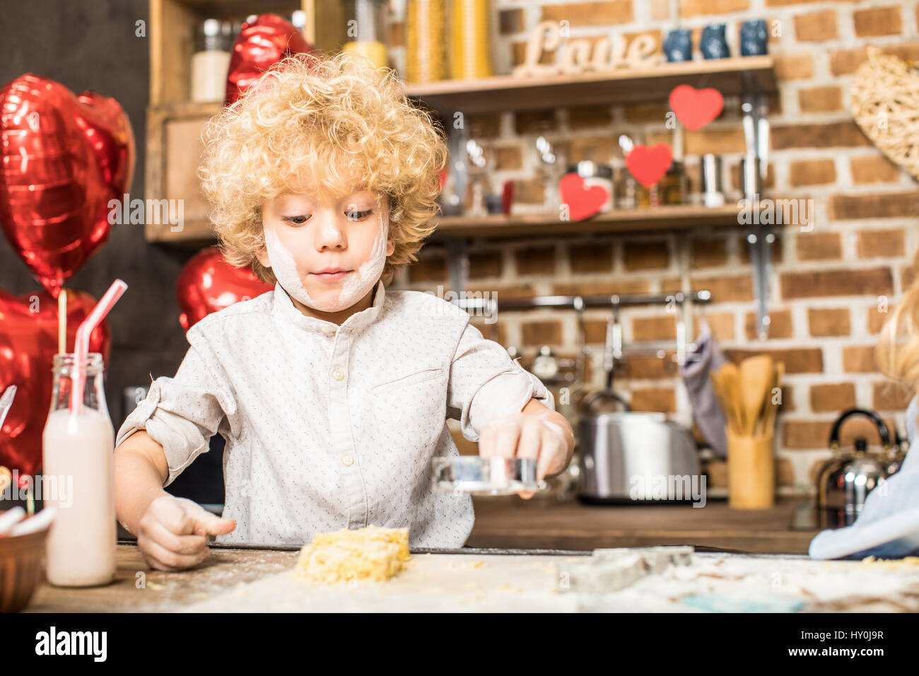 Portrait of little boy with flour-streaked face making cookies Stock ...