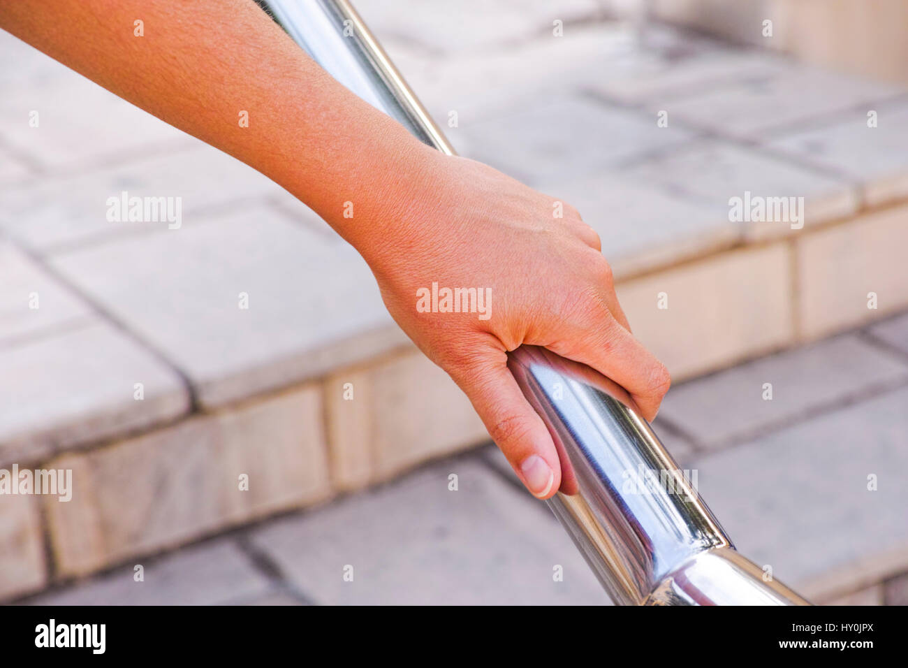 Woman hand using a handrail in the street Stock Photo - Alamy