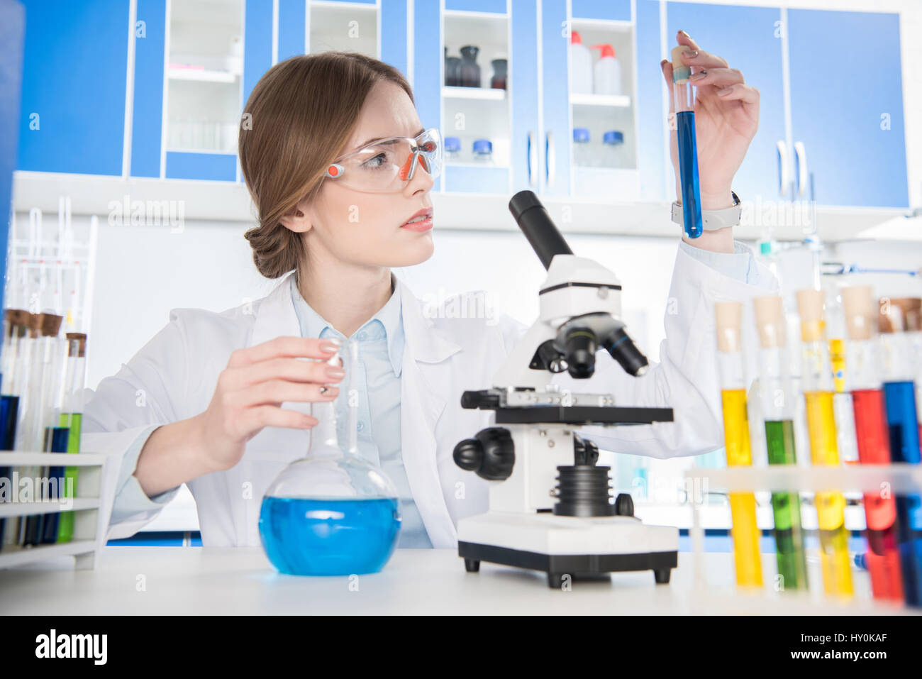 Young female scientist making chemical experiment in laboratory Stock ...