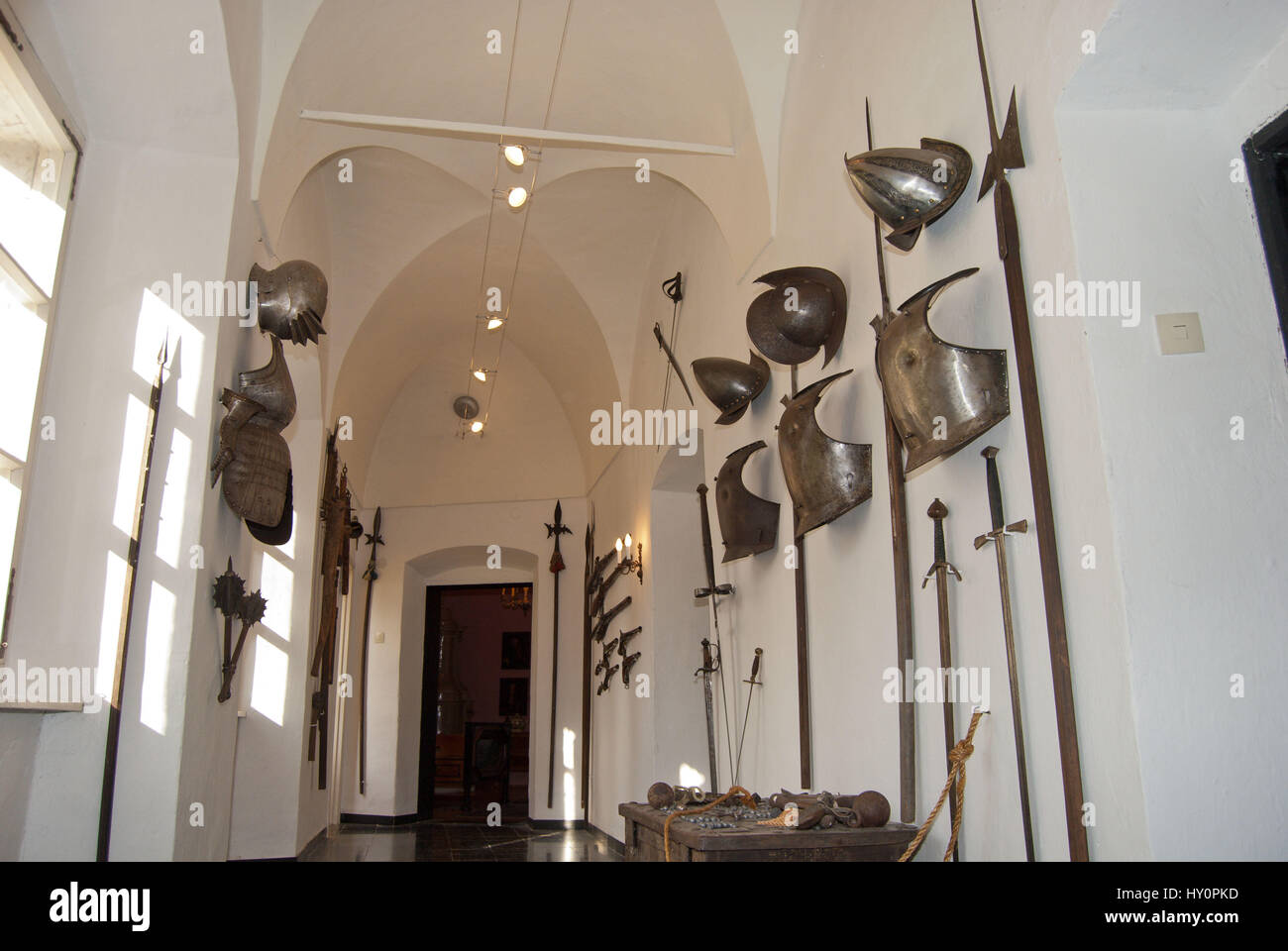 Medieval helmets, cuirass, swords, pistols and halberds as decoration ...