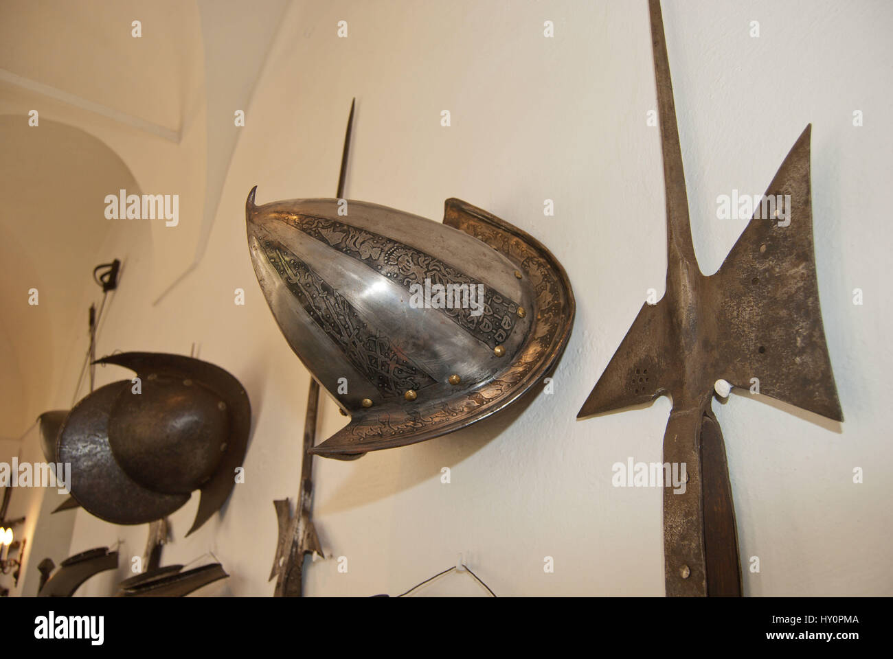 Medieval helmets and halberds as decoration in an interior of an old ...
