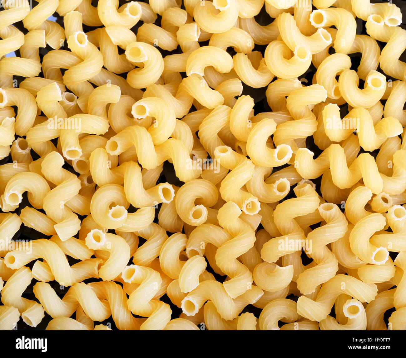 Elbow macaroni pasta food in pile Stock Photo - Alamy