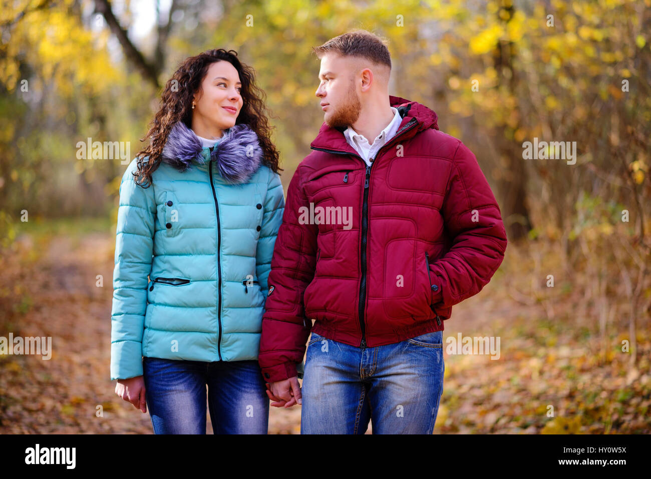 Lovers walking hand in hand in autumn park Stock Photo - Alamy