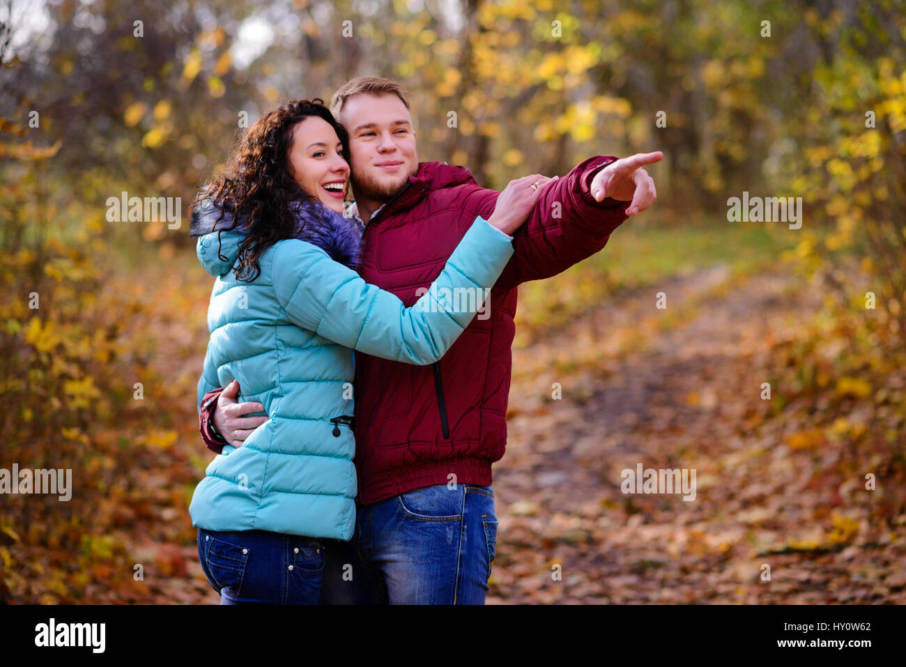 Lovers walking hand in hand in autumn park Stock Photo - Alamy