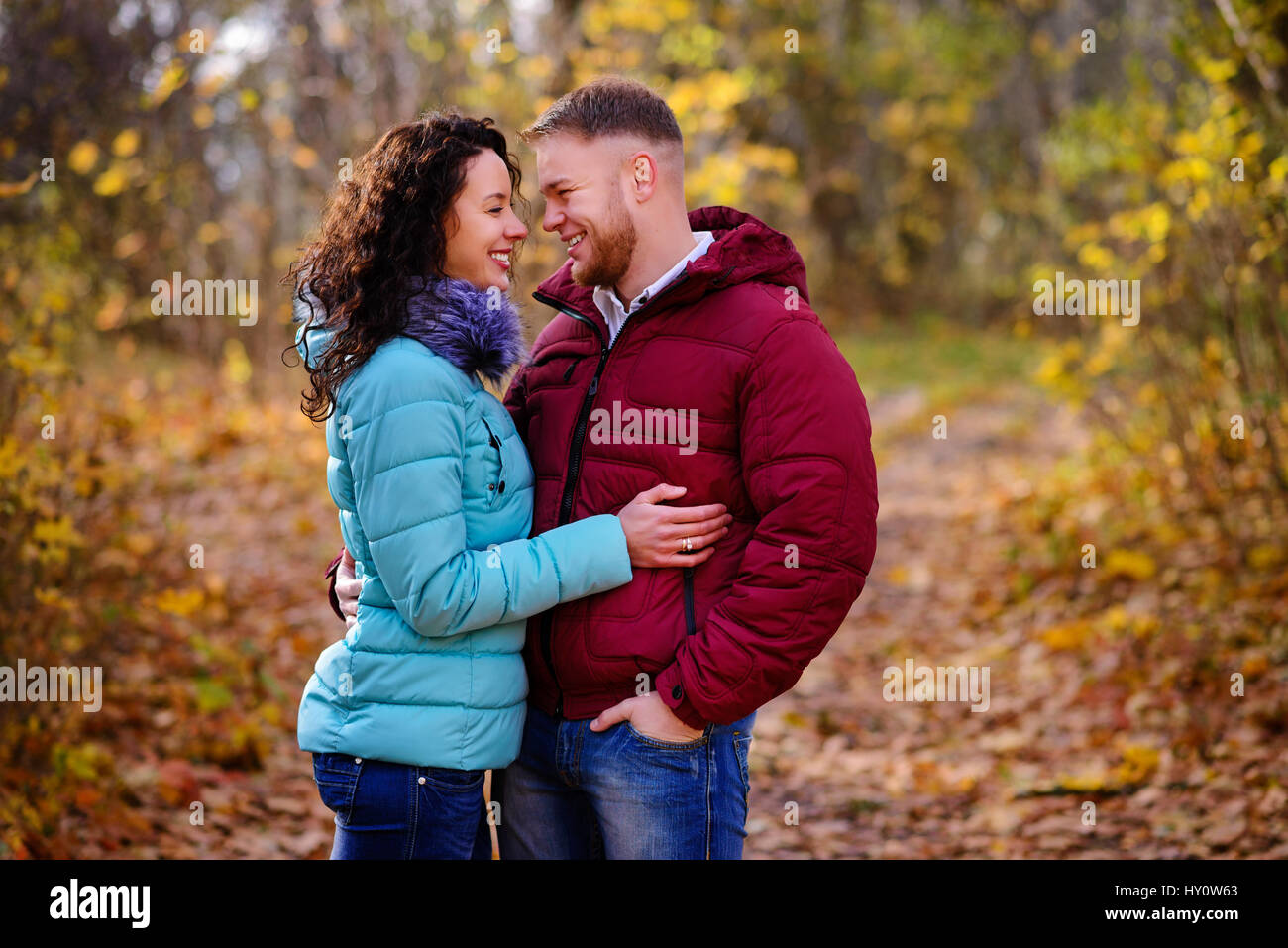 Lovers walking hand in hand in autumn park Stock Photo - Alamy