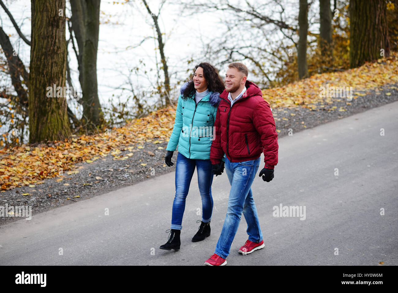 Lovers walking hand in hand in autumn park Stock Photo - Alamy