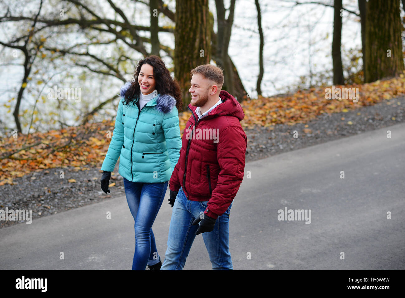 Lovers walking hand in hand in autumn park Stock Photo - Alamy