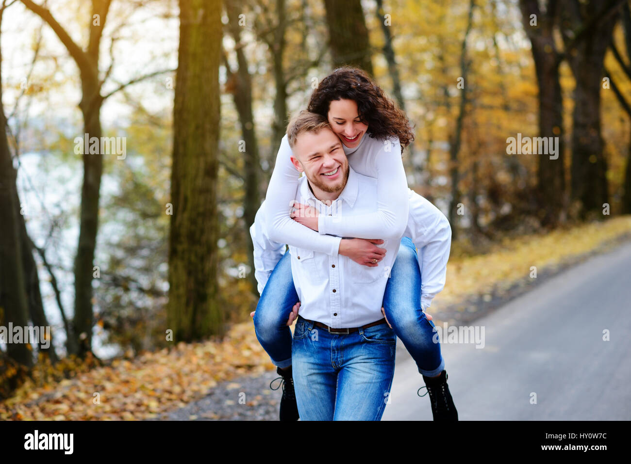 Lovers walking hand in hand in autumn park Stock Photo - Alamy