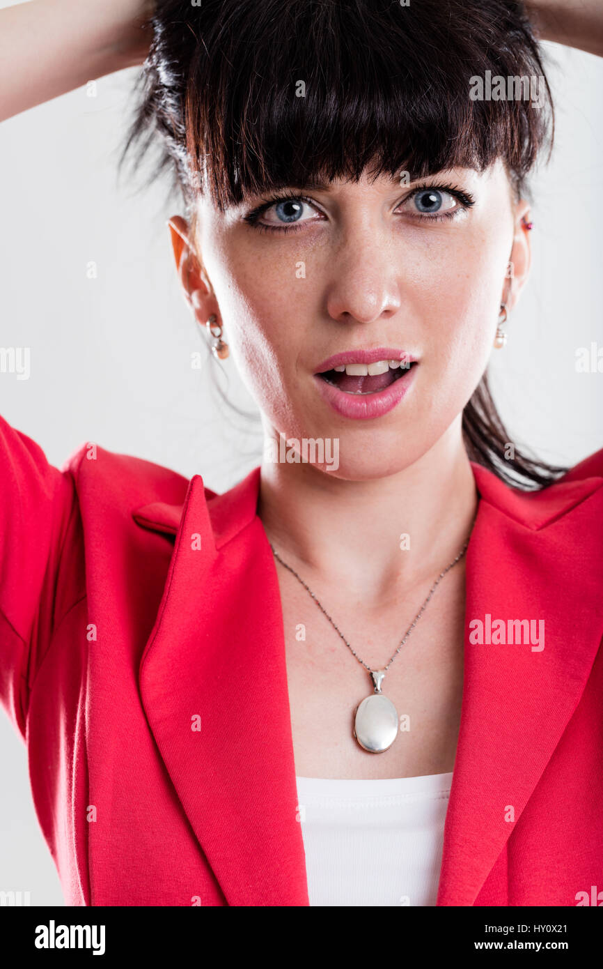 theatrical expression of a shocked woman in a staged studio portrait ...