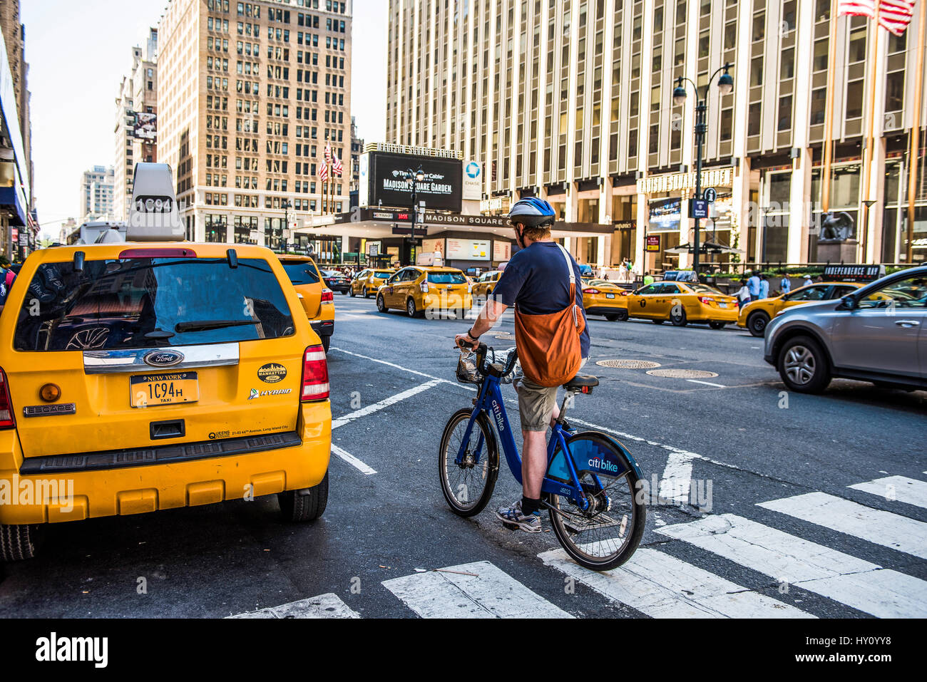 New York City, USA - June 18, 2016: Man on a bicycle crossing road ...