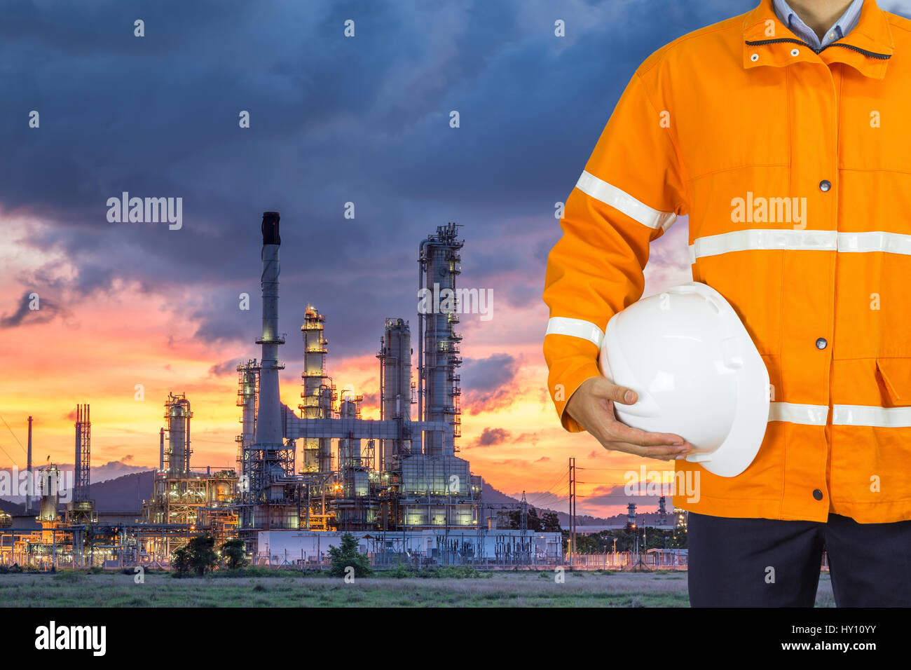 Engineer oil industry wearing safety coat and holding safety helmet in ...