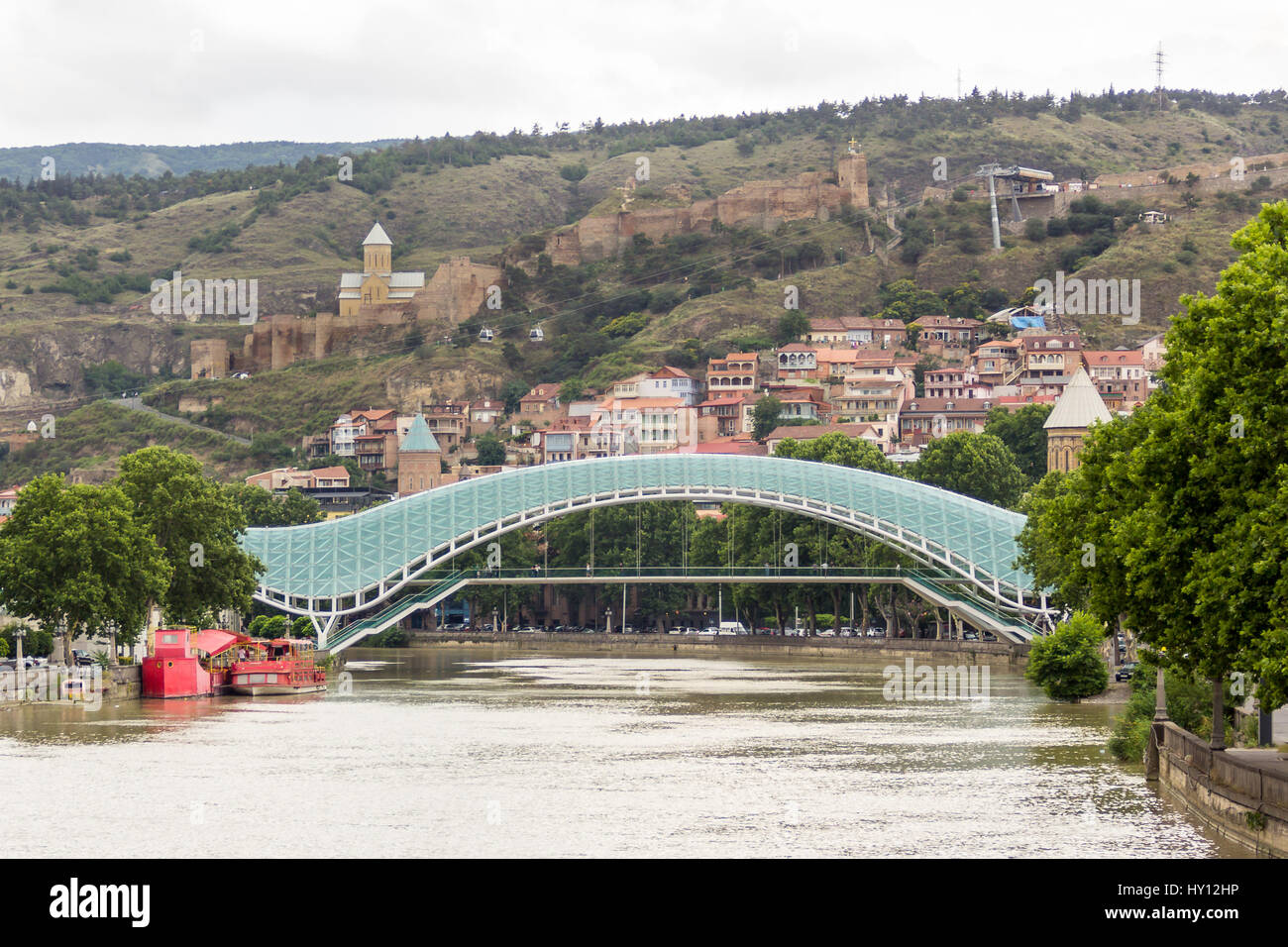 The aerial view of the Kura river, surrounded by greenery and the Peace ...