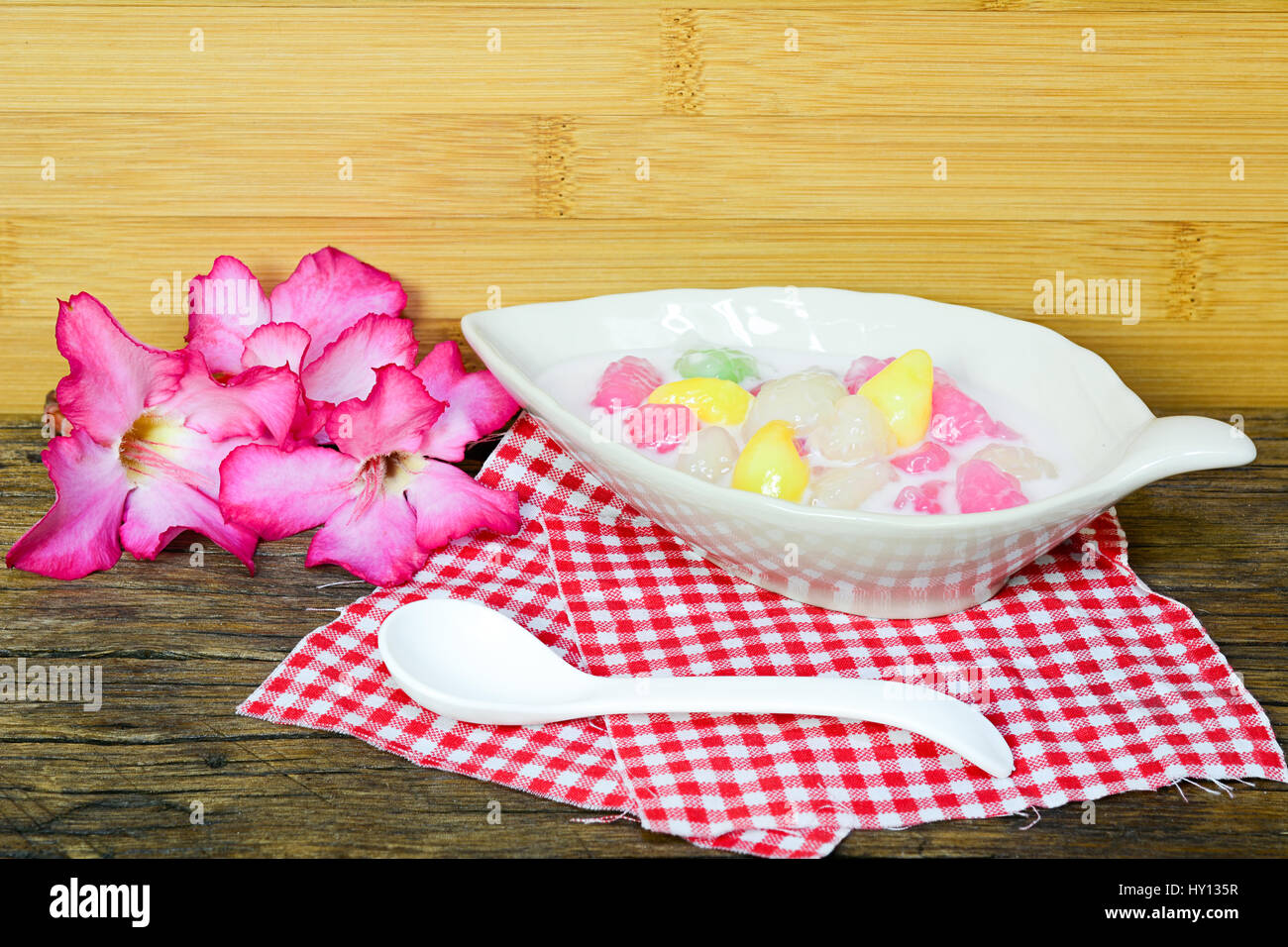 Crispy water chestnuts in coconut cream with spoon and flower Stock ...