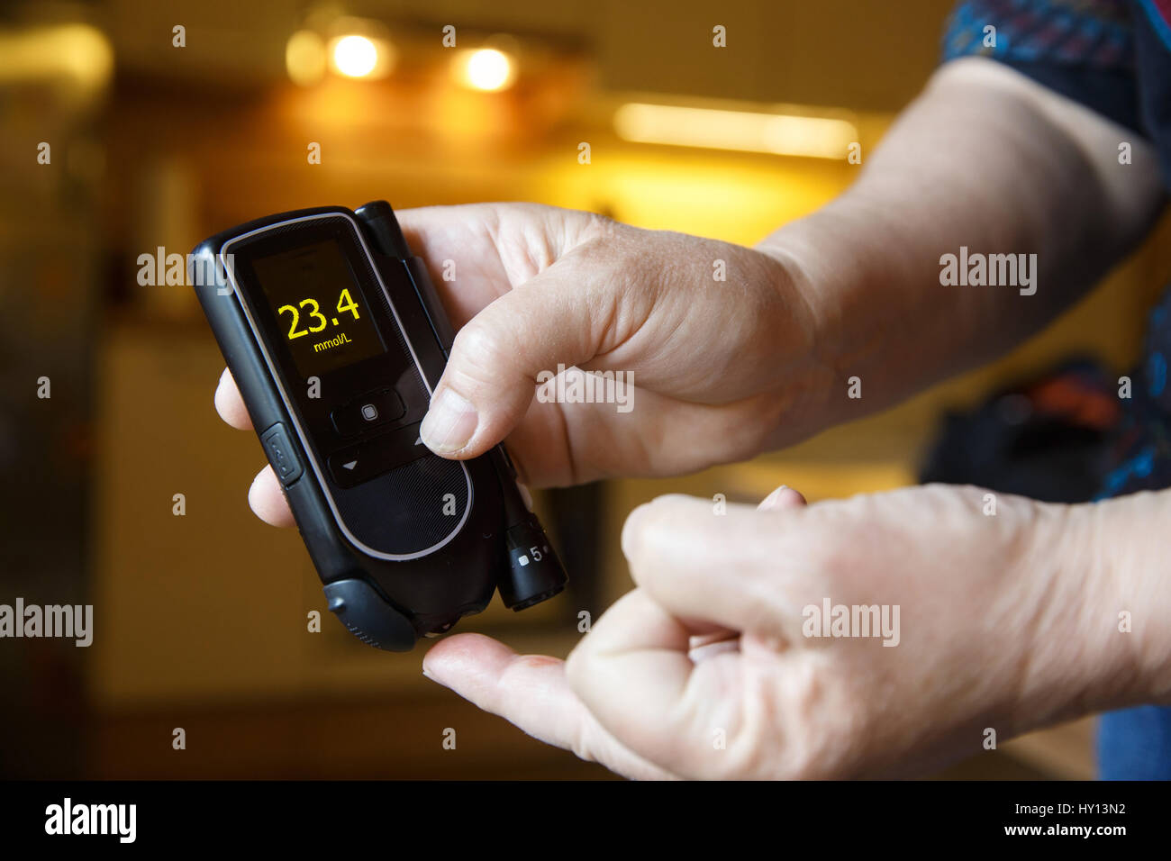 Hyperglycemic diabetic patient testing her blood for sugar level at ...