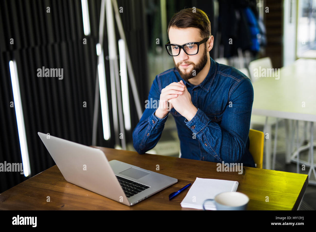 Man working at laptop in contemporary office Stock Photo - Alamy