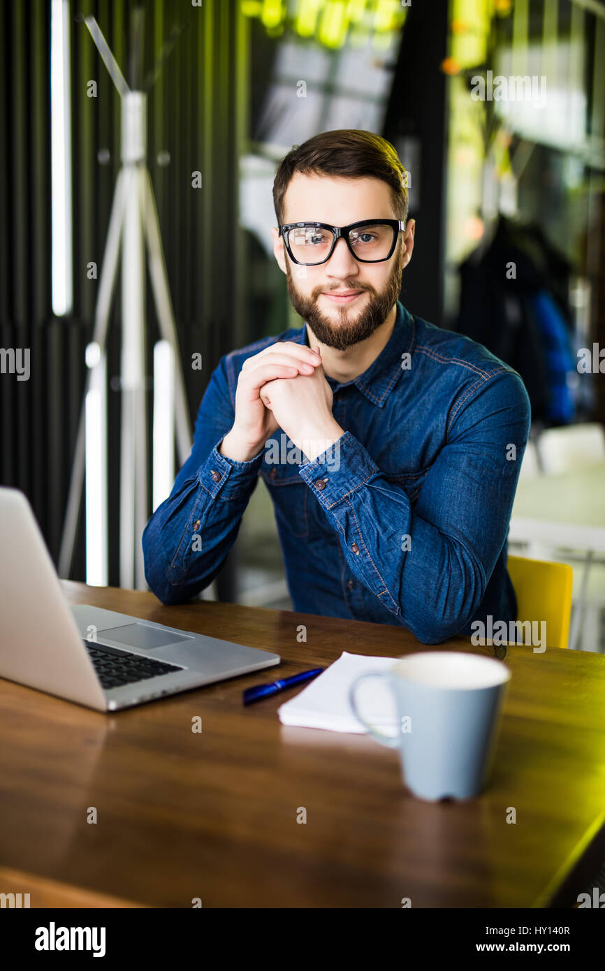 Man working at laptop in contemporary office Stock Photo - Alamy