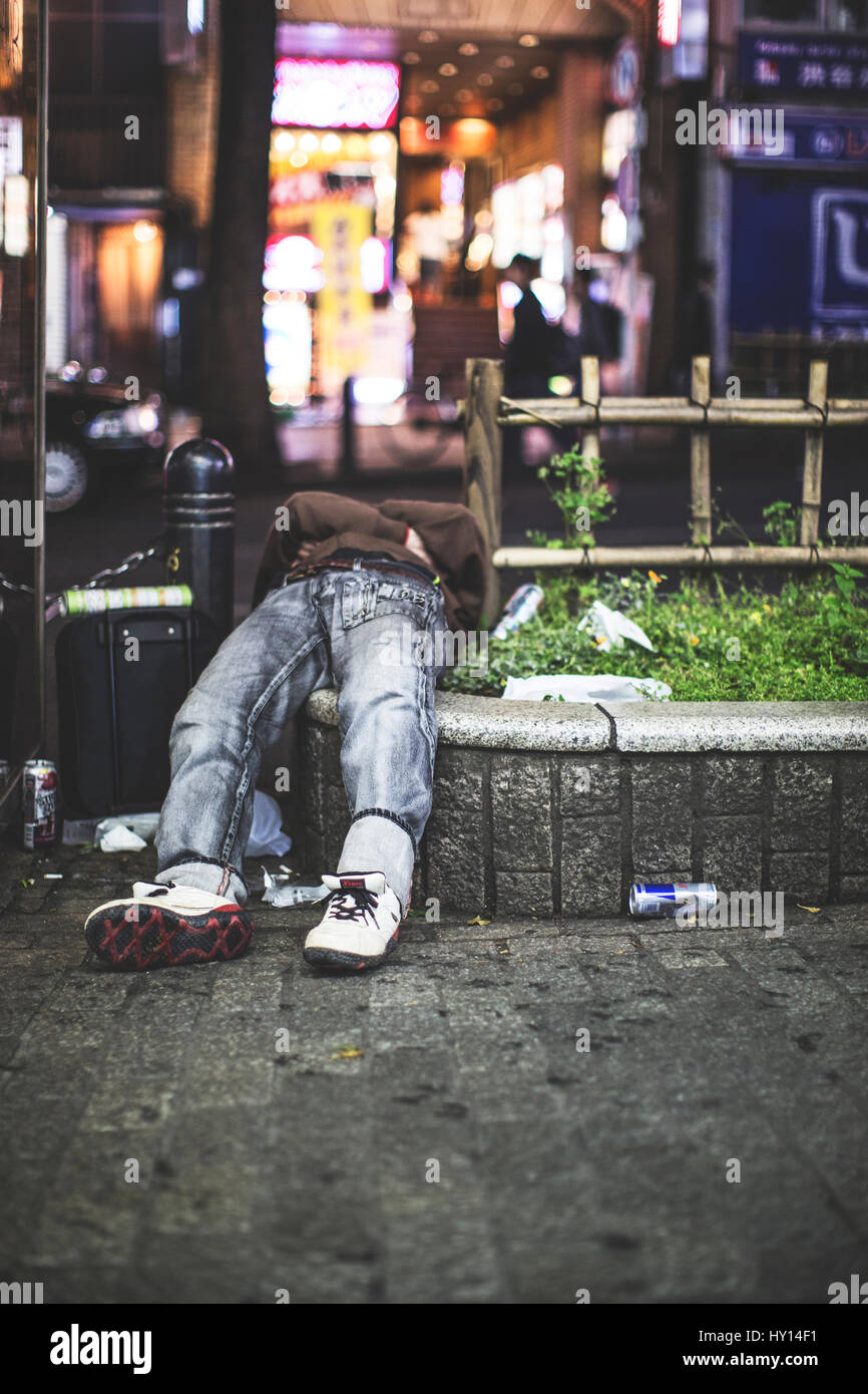 A homeless man is sleeping on the street in Tokyo, Japan Stock Photo ...