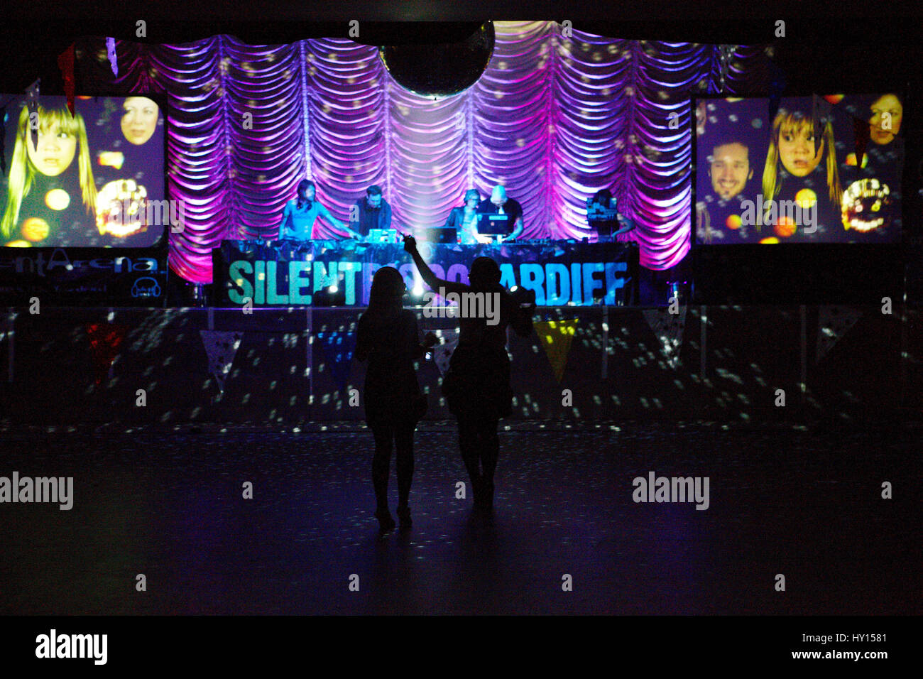 People stood infront of the DJ booth at the silent disco, SWN festival ...