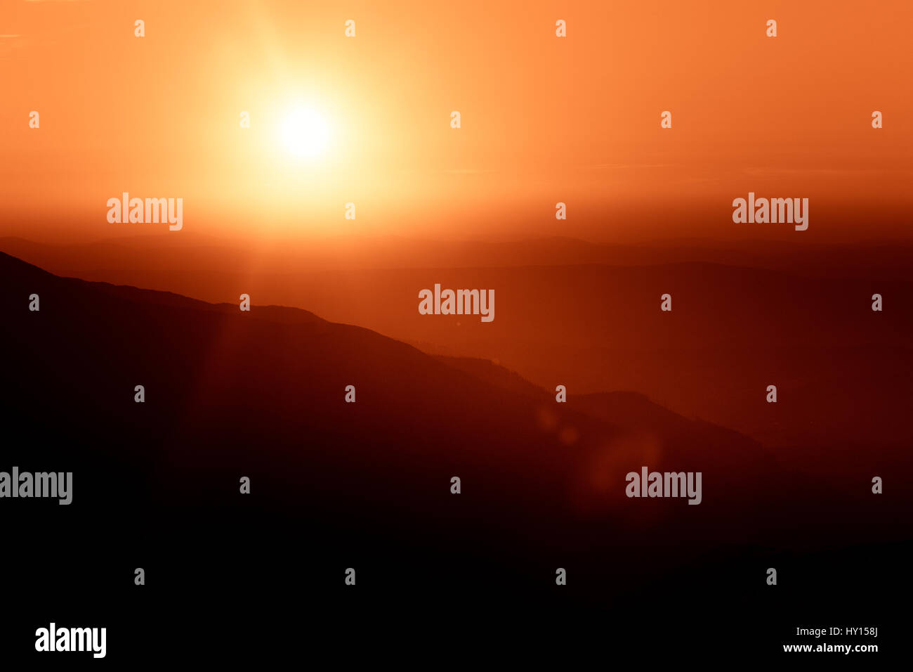 A beautiful, colorful, abstract mountain landscape with sun in a red ...