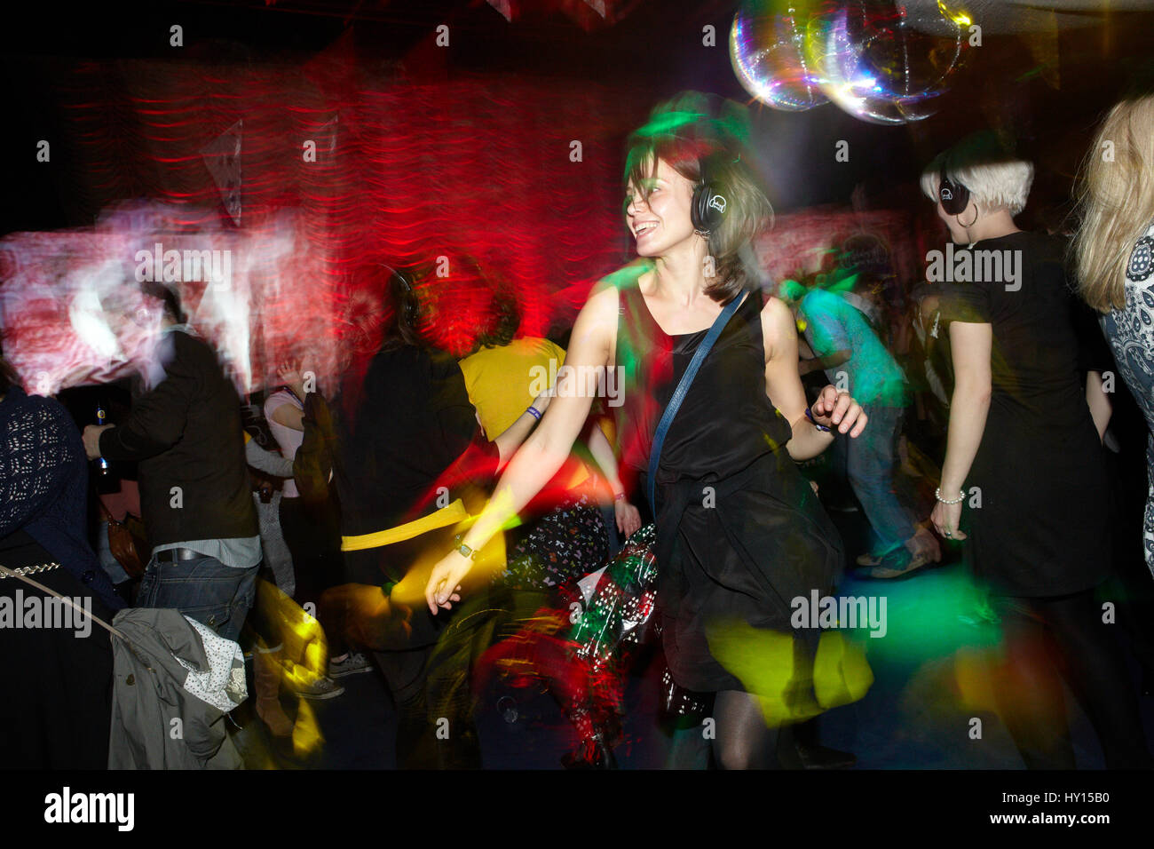 Woman in a black dress dancing at a silent disco, SWN festival, Cardiff ...