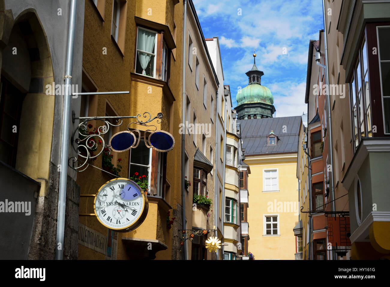 A clock and glasses sign hanging on the wall of a shop, Innsbruck ...