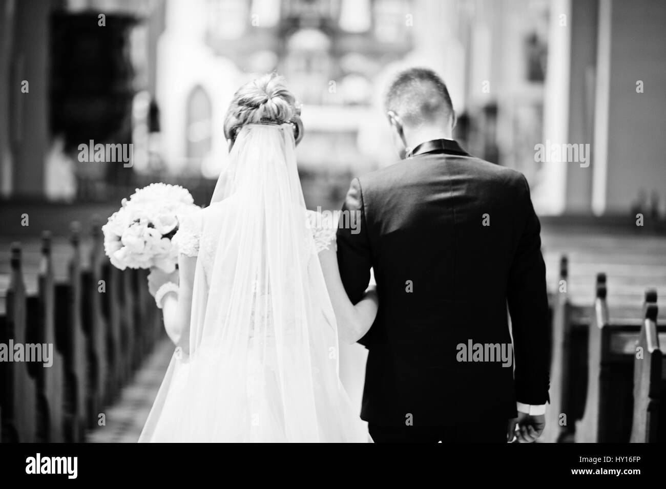Photosession of stylish wedding couple on catholic church Stock Photo ...
