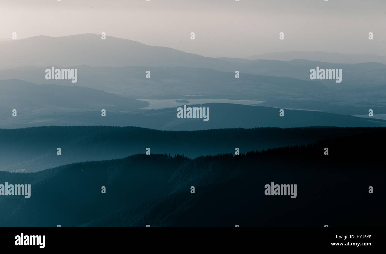 A beautiful, abstract monochrome mountain landscape in blue tonality ...