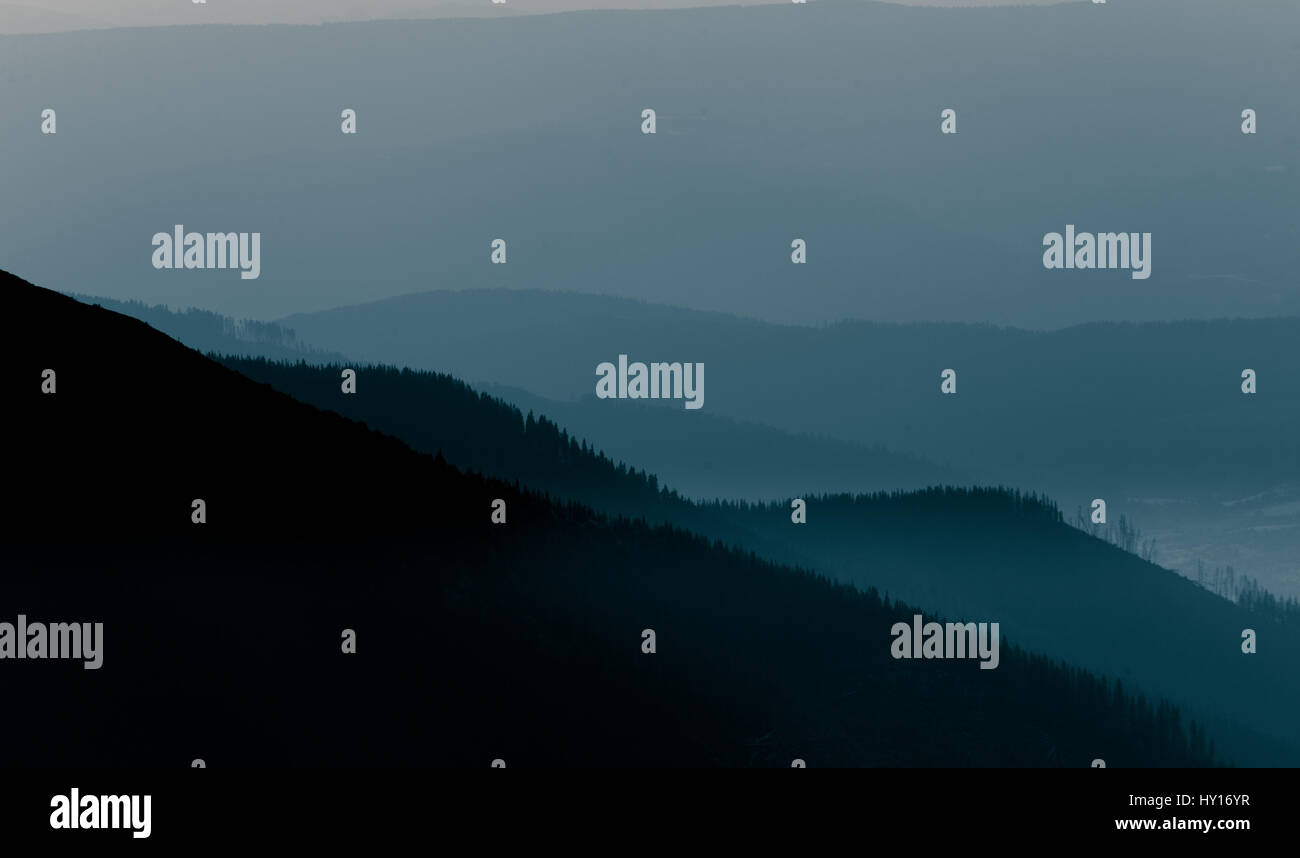 A beautiful, abstract monochrome mountain landscape in blue tonality ...