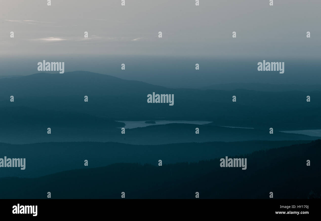 A beautiful, abstract monochrome mountain landscape in blue tonality ...