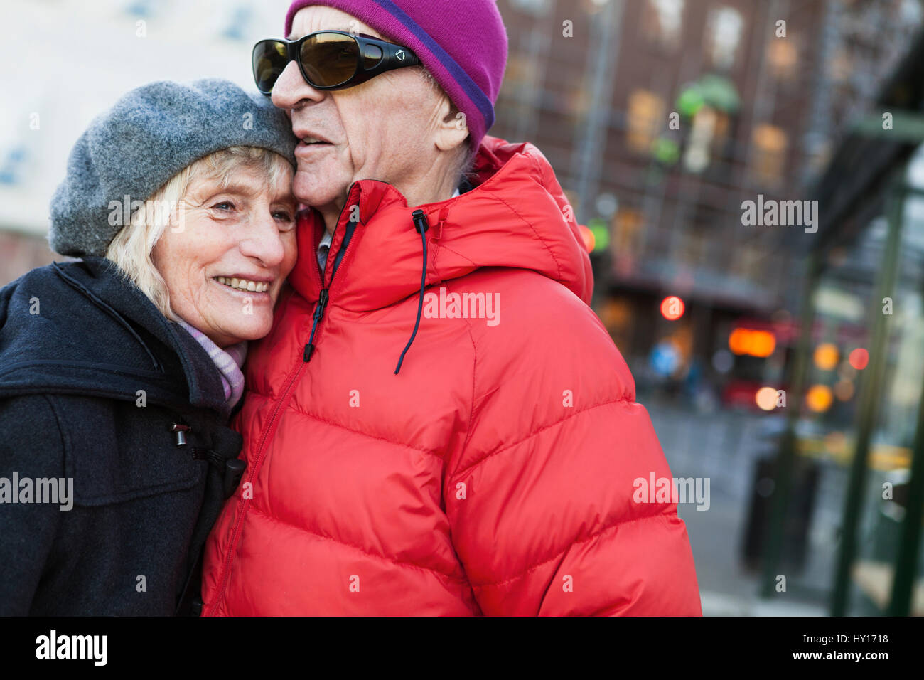 Sweden, Stockholm, Sodermalm, Senior couple hugging at bus stop Stock ...
