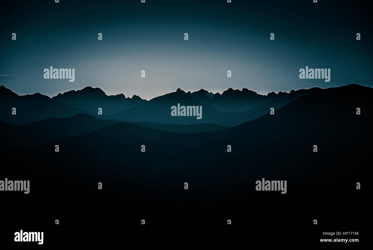 A beautiful, abstract monochrome mountain landscape in blue tonality ...