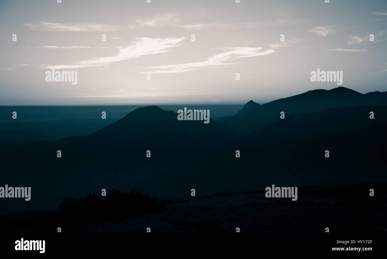 A beautiful, abstract monochrome mountain landscape in blue tonality ...