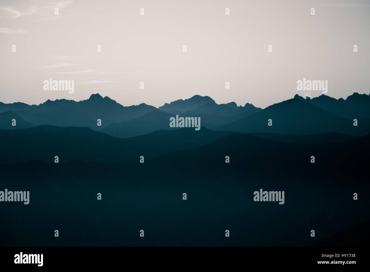 A beautiful, abstract monochrome mountain landscape in blue tonality ...