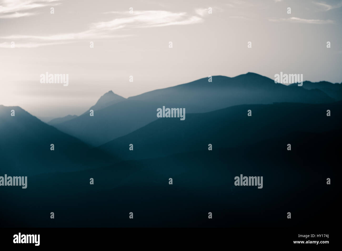 A beautiful, abstract monochrome mountain landscape in blue tonality ...