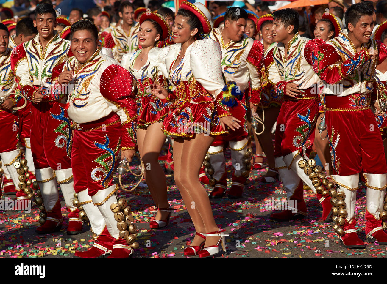 Caporales dance group in ornate red and white costume performing at the ...