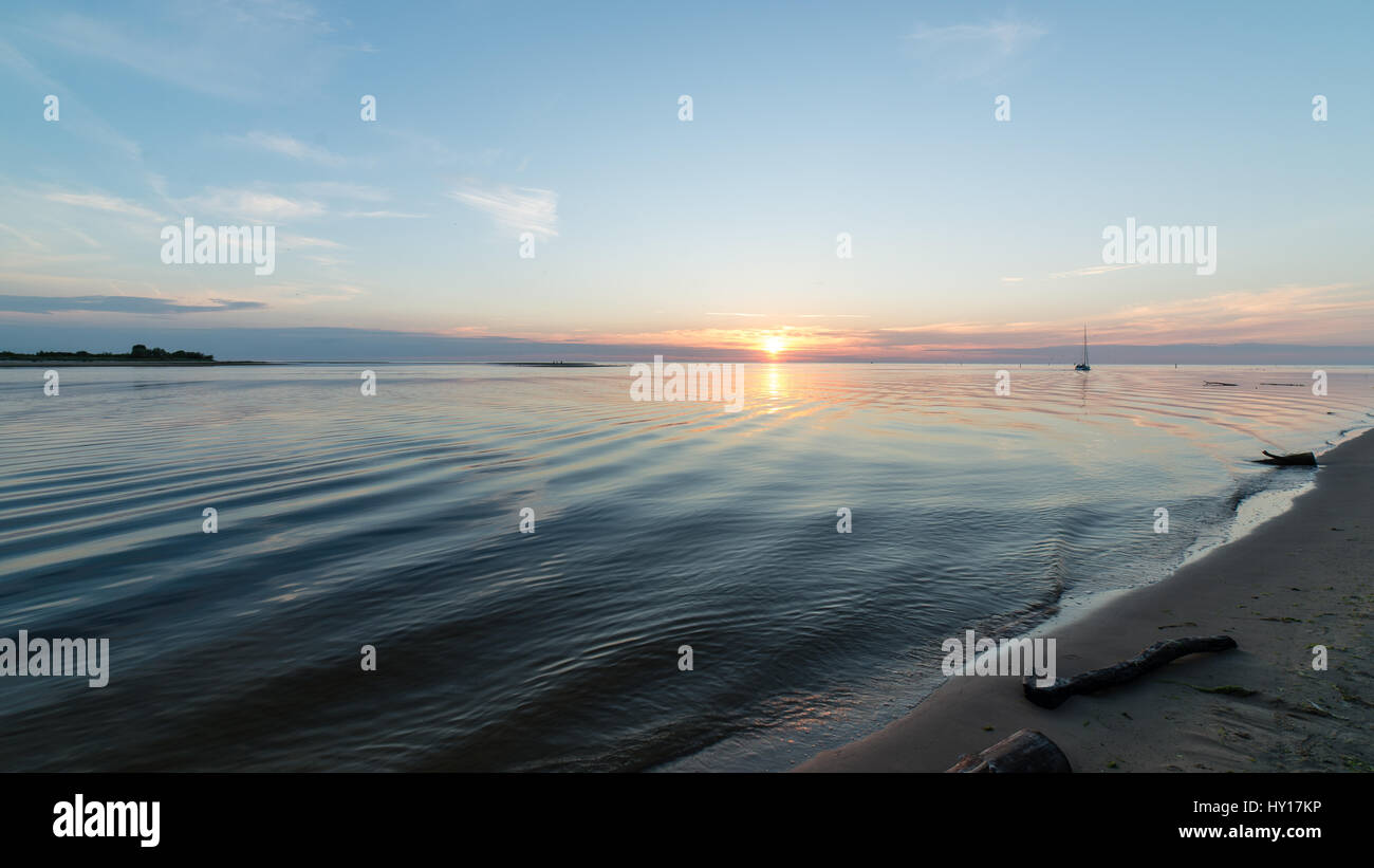 Beautiful sunset over the sea with clouds and reflections Stock Photo ...