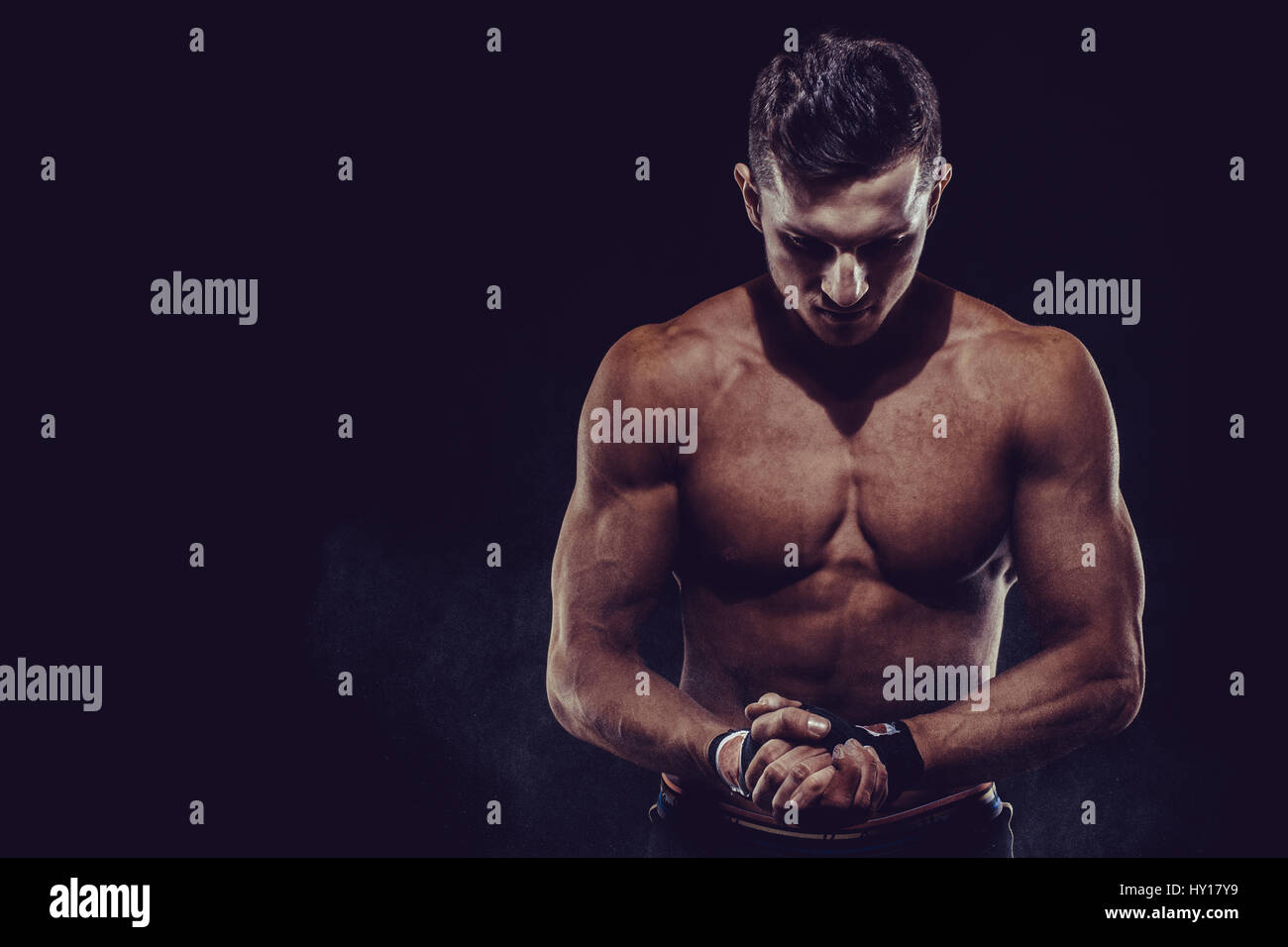 MMA Fighter Preparing Bandages For Training. Dark background Stock ...